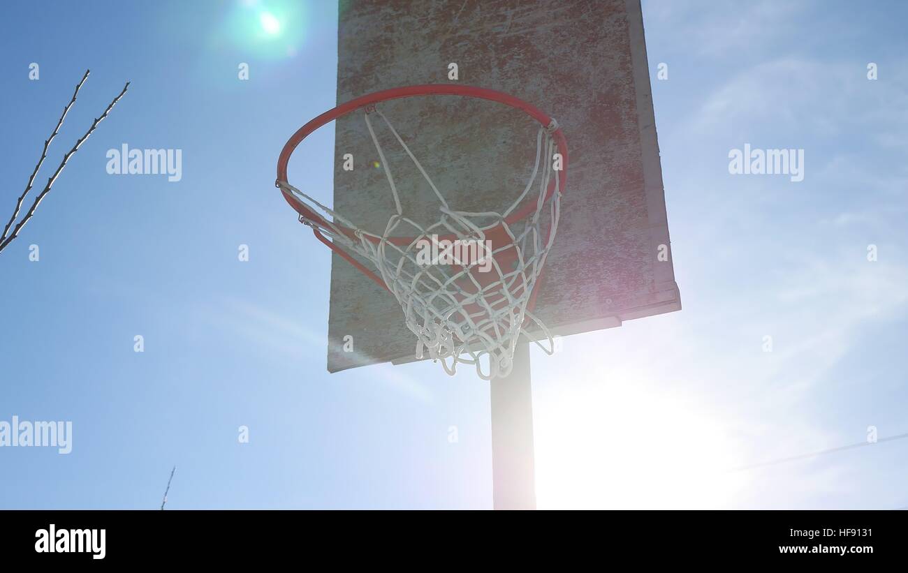old basketball hoop sport street against a blue Stock Photo - Alamy