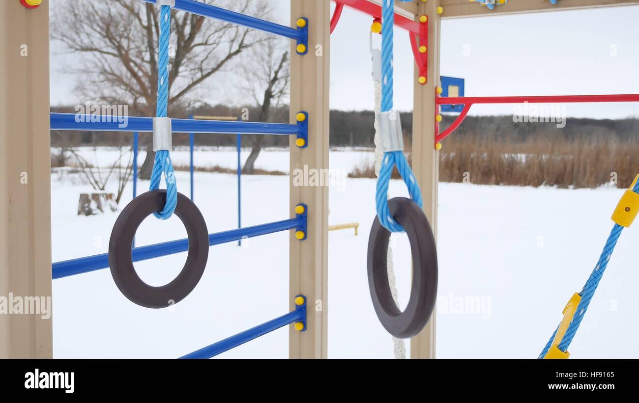 children playground gymnastic rings swing, winter snow landscape Stock ...