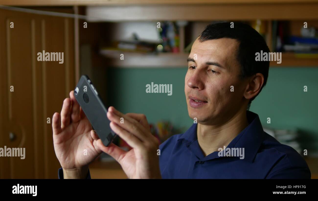 man makes a funny selfie phone smartphone indoor Stock Photo - Alamy