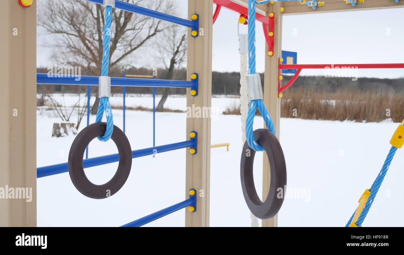 children playground gymnastic rings swing, winter snow landscape Stock ...