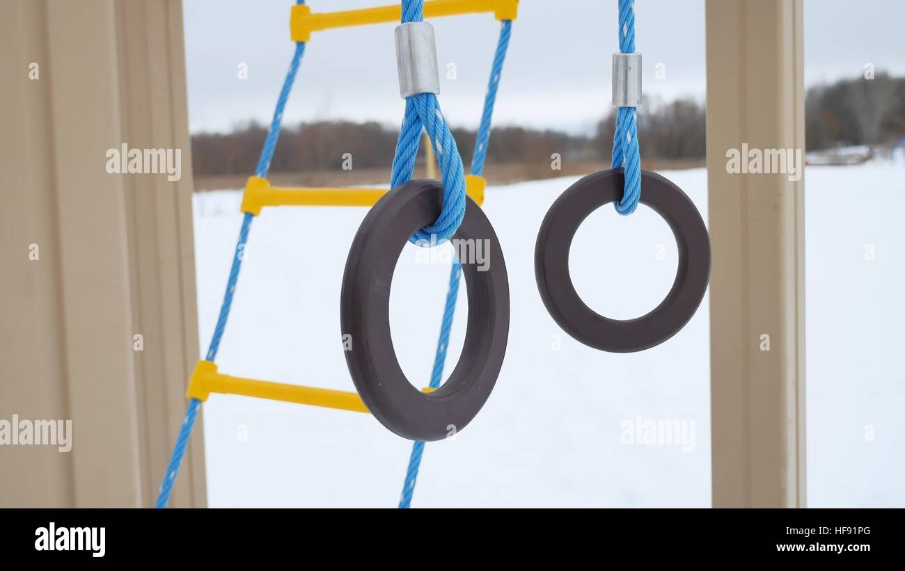 children playground gymnastic rings swing, snow winter landscape a ...