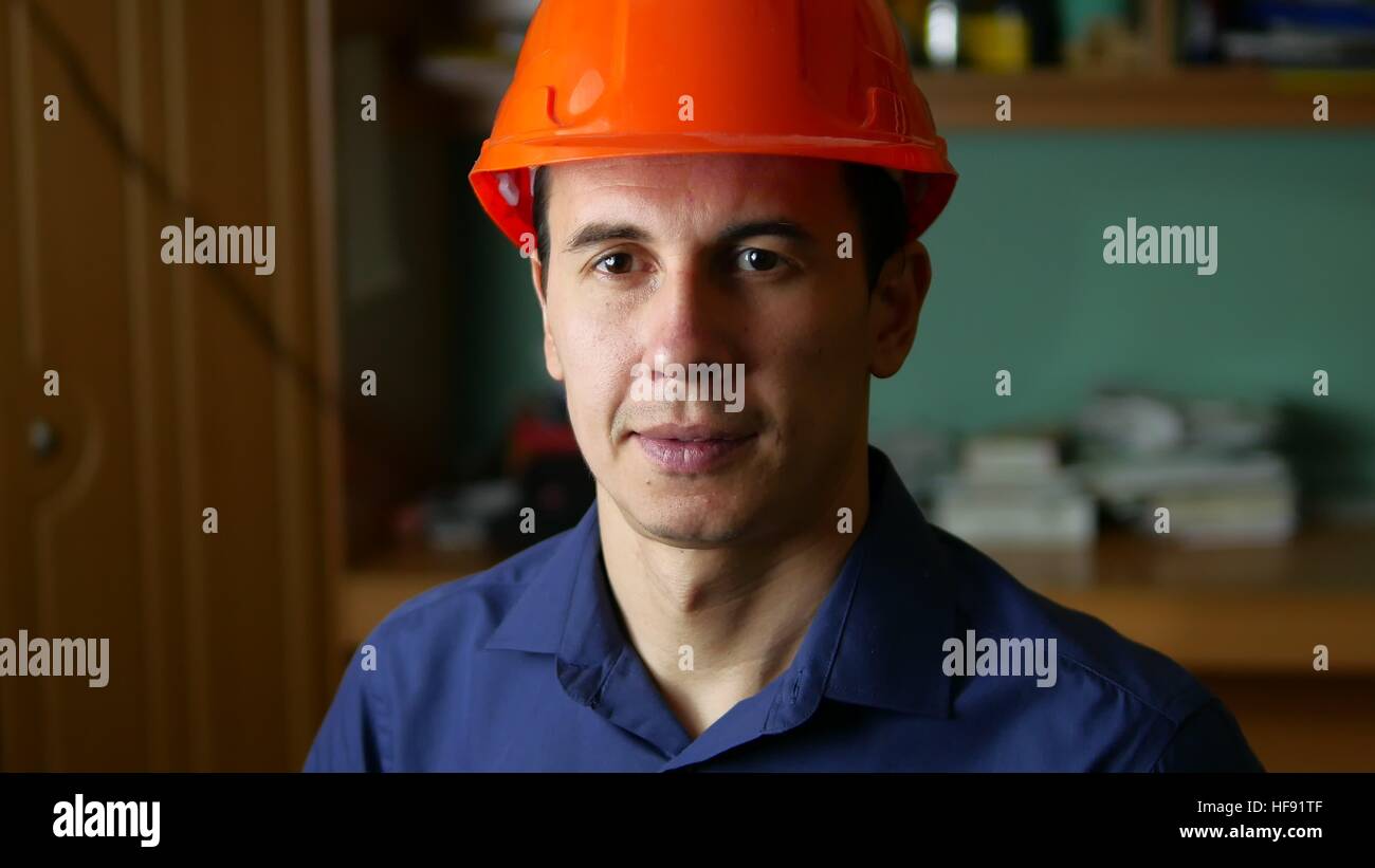 man construction worker in a hard hat portrait indoor Stock Photo - Alamy