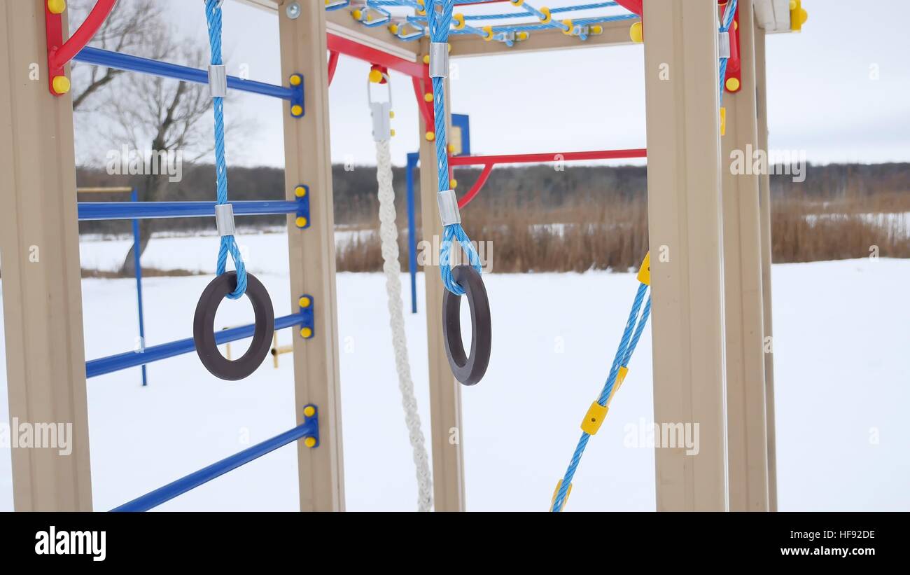 children playground gymnastic rings swing, snow landscape a winter ...