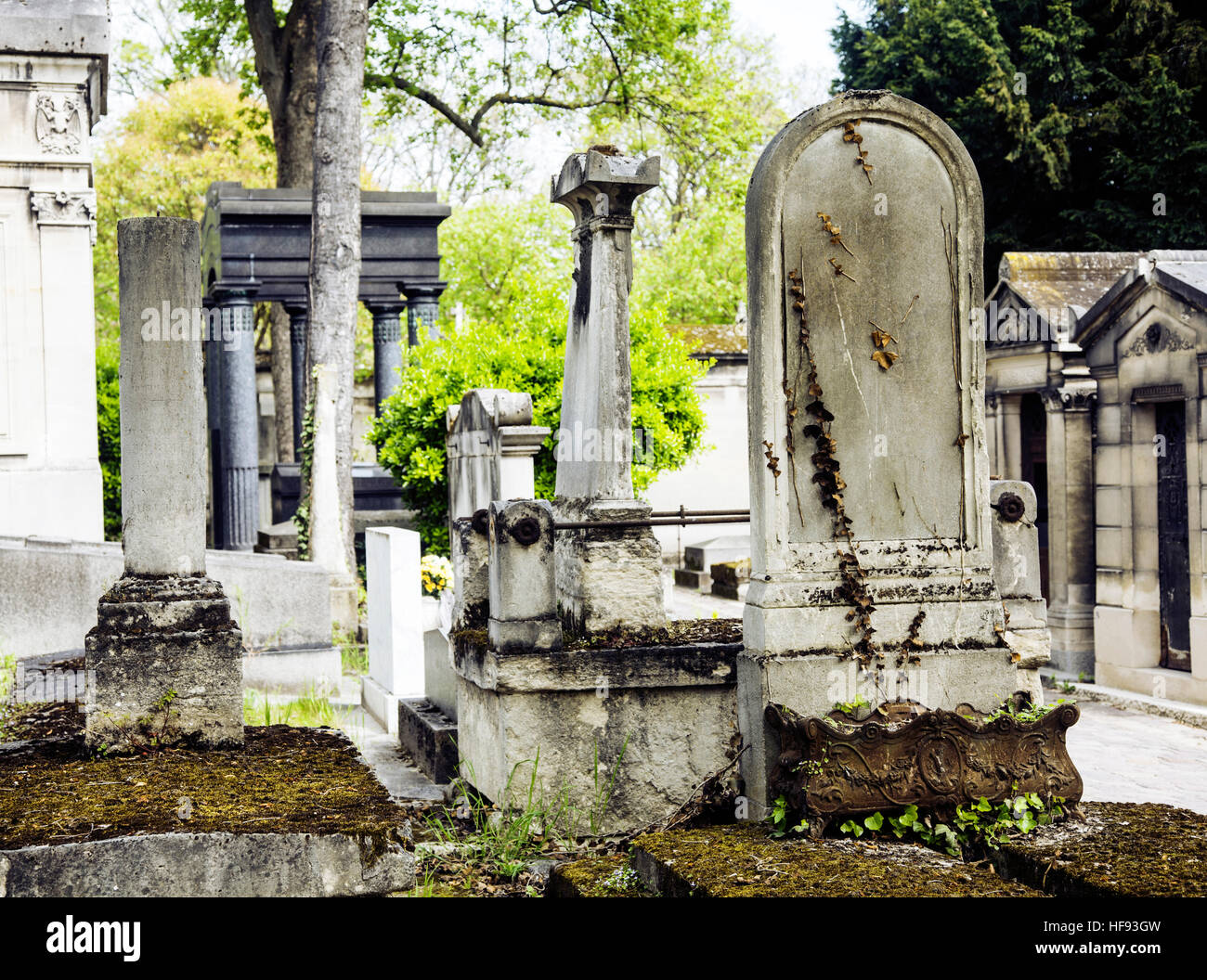 Tombstones in cemetery at dusk, gothic style crosses Stock Photo - Alamy
