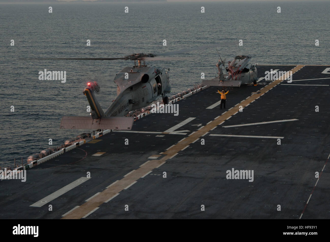 A Brazilian S-70B Seahawk helicopter is directed to land aboard the ...