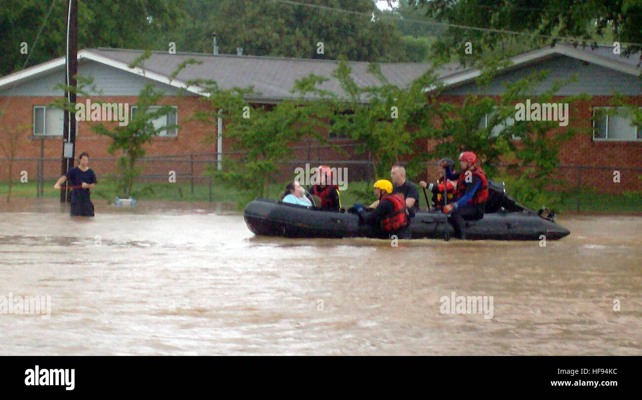 Rescue personnel navigate flooded streets in the family housing section ...