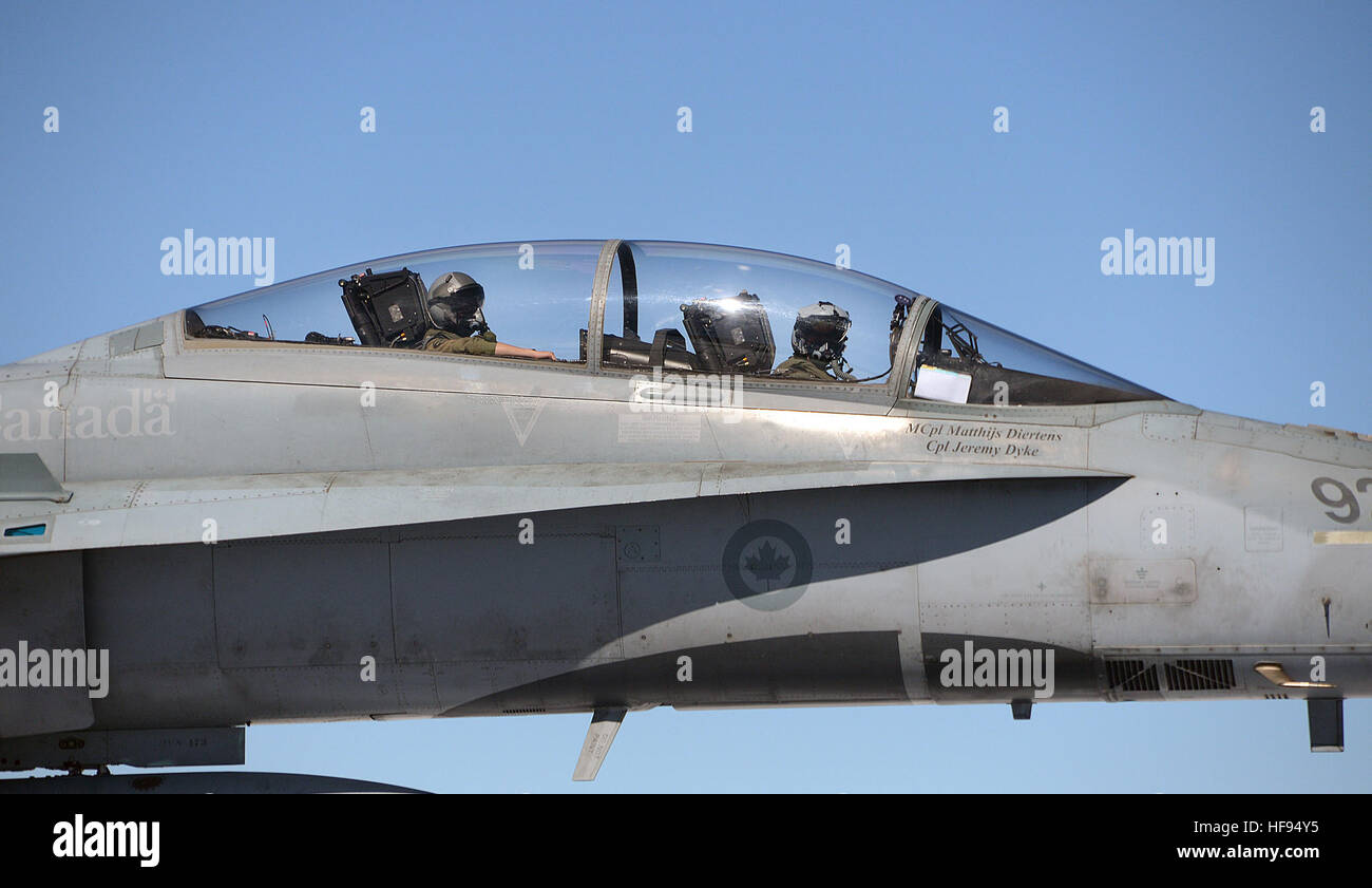 A CF-18 Hornet fighter jet from 409 Squadron completes fueling with a ...