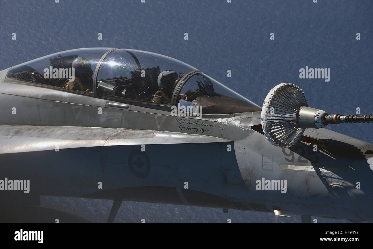 A Canadian CF-18 Hornet fighter jet from 409 Squadron receives fuel ...