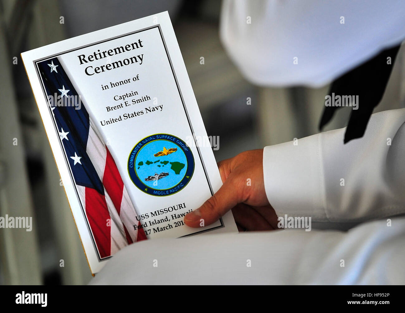 A Sailor holds a brochure for the Capt. Brent Smith, chief of staff ...