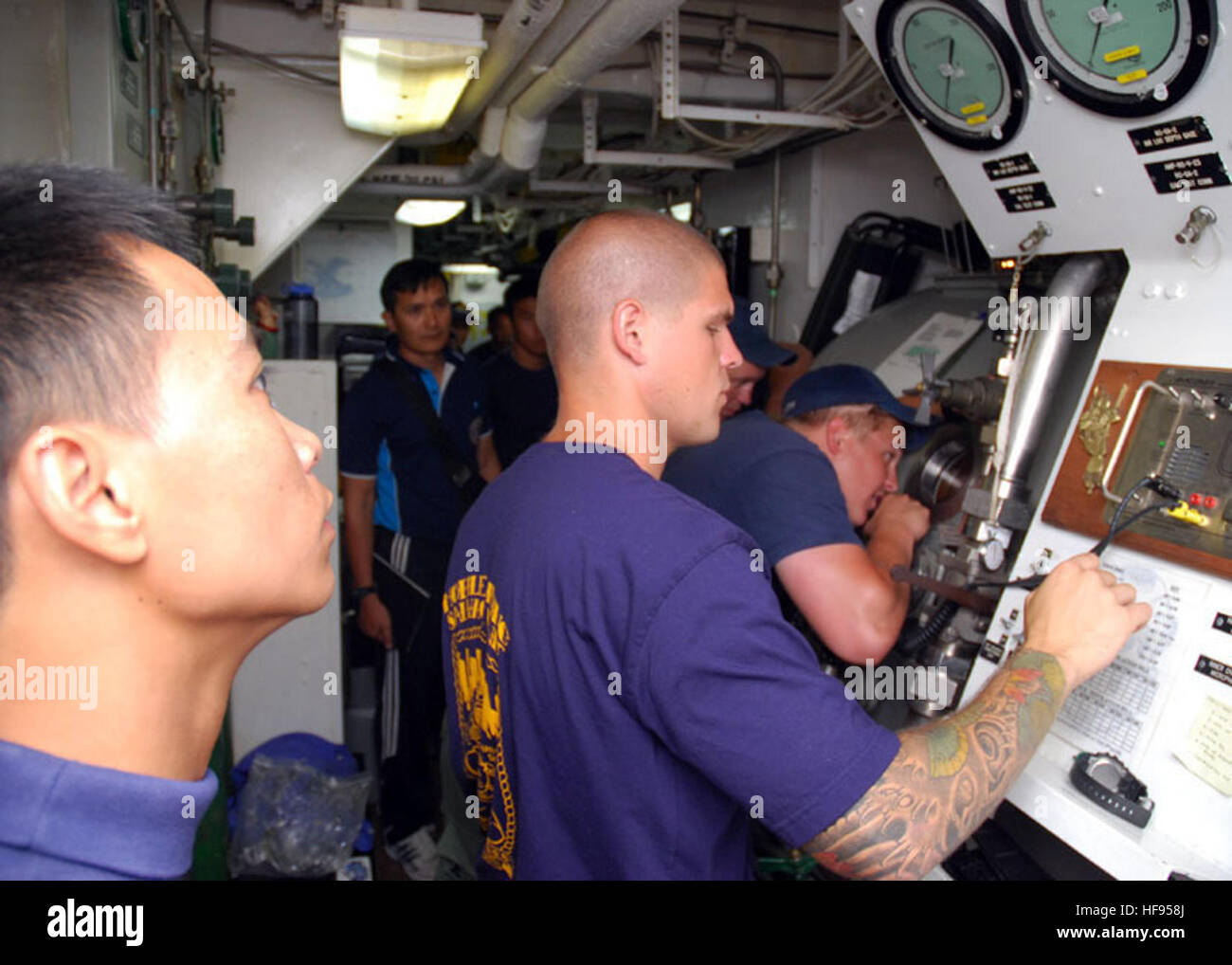 U.S. Navy divers demonstrate the use of a hyperbaric recompression ...