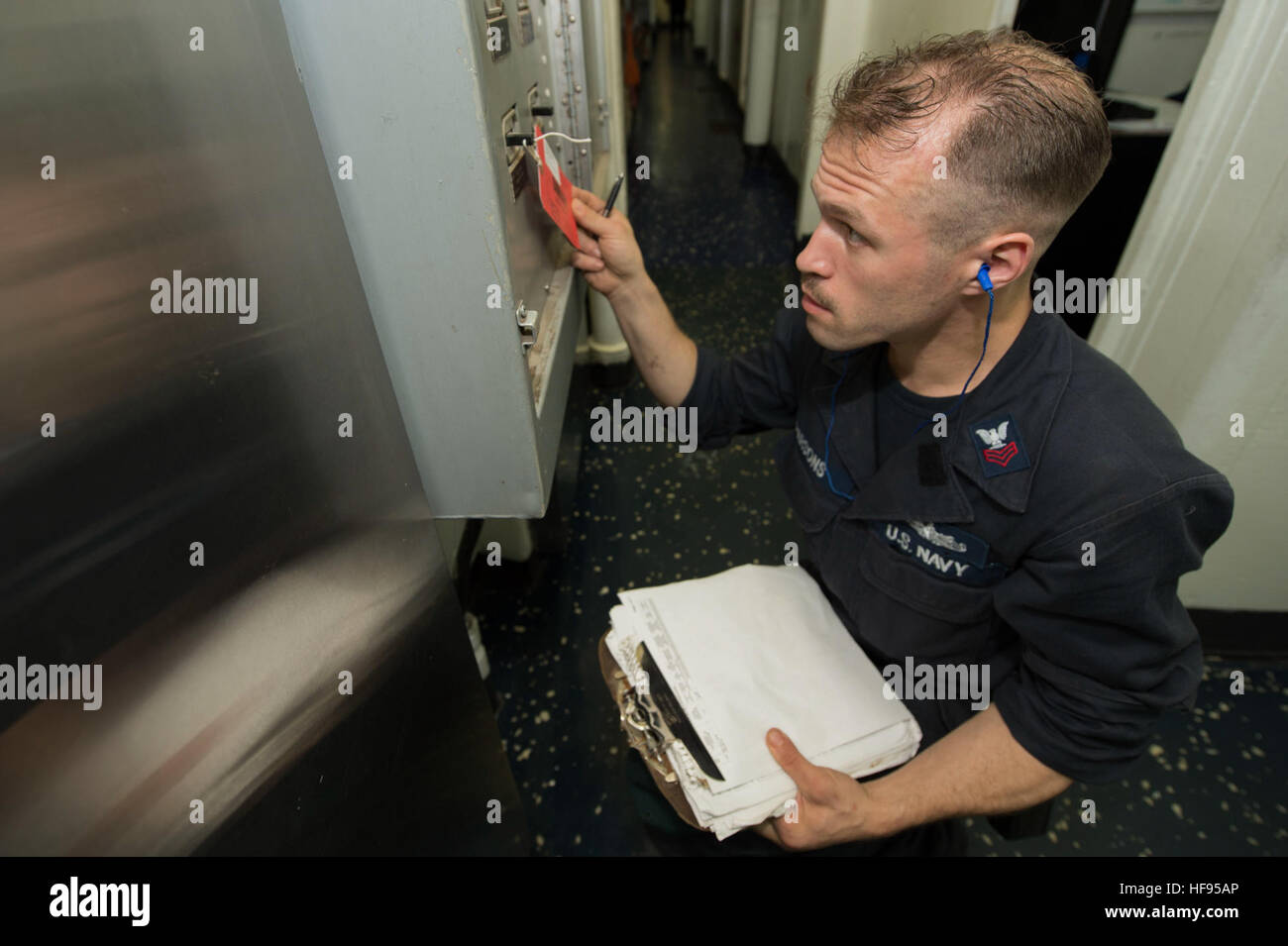 U.S. Navy Damage Controlman 1st Class William Parsons conducts a tag ...