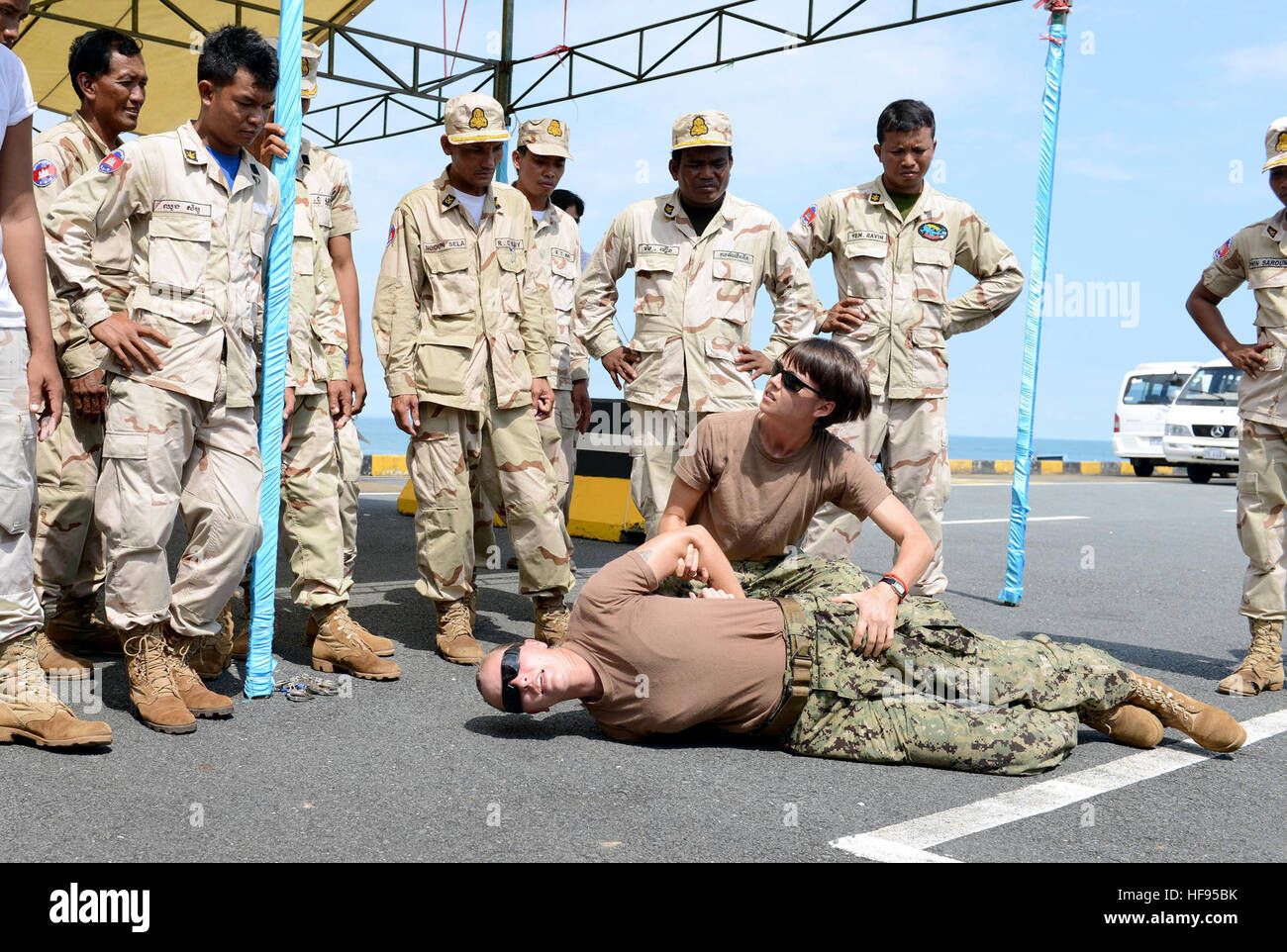Master-at-Arms 2nd Class Rachel Arp demonstrates handcuffing techniques ...