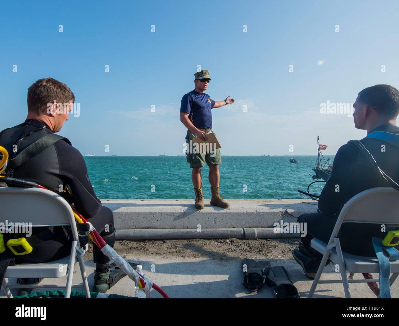U.S. Navy Diver 1st Class Matthew Dipaolo, center, assigned to ...