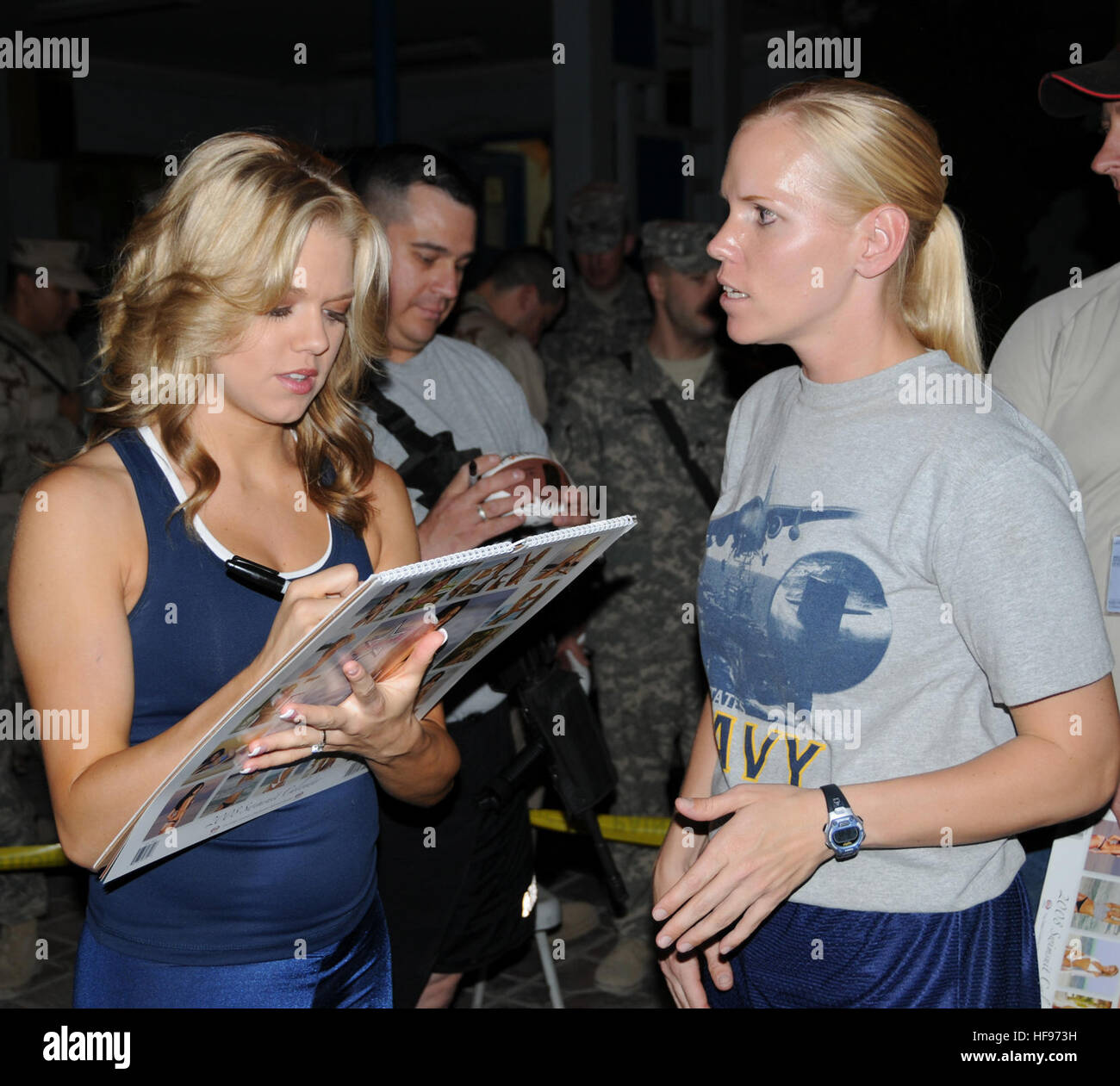 Christine Parker (left), Dallas Cowboys cheerleader, signs an autograph ...