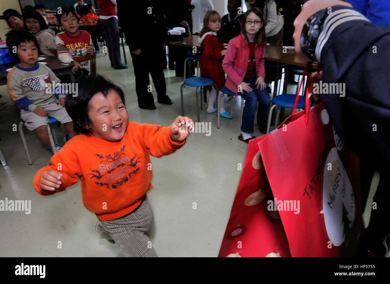 A child from the Shunko Gakuen Orphanage in Yokosuka, Japan, runs to ...