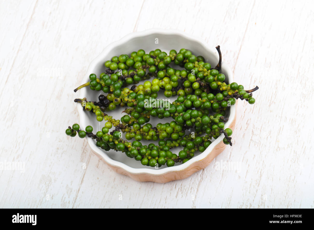 Green pepper corn on the branch in plate Stock Photo - Alamy
