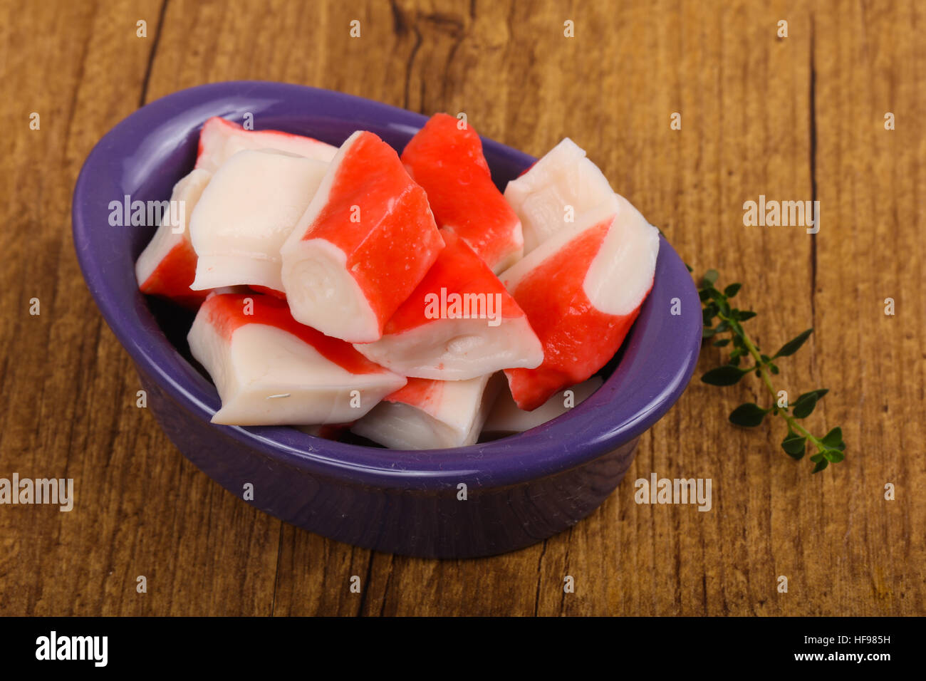 Crab stick - surimi in the plate - over wood background Stock Photo - Alamy
