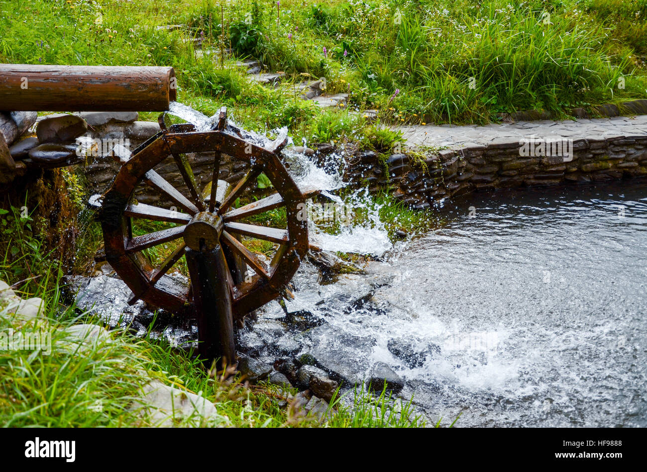 Working watermill wheel with falling waterin the village Stock Photo ...