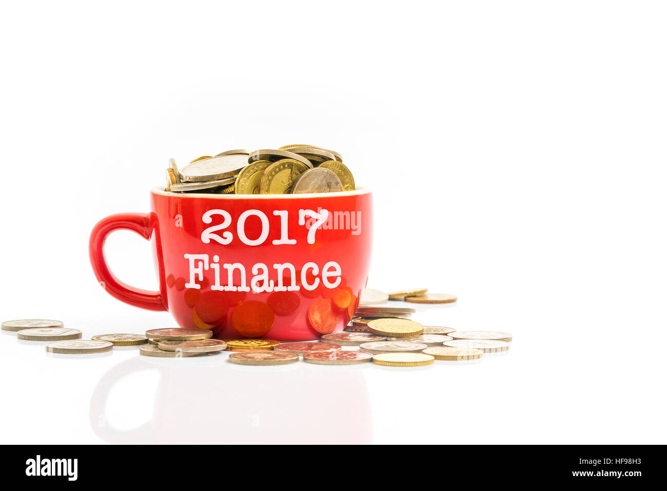 red cup full with coins and text of financial concept Stock Photo - Alamy