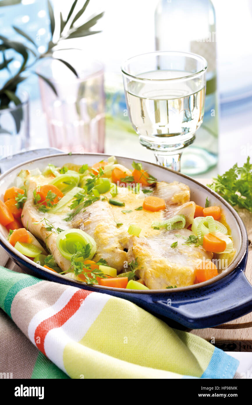 Mediterranean seafood dish: ocean perch filets on a bed of vegetables ...