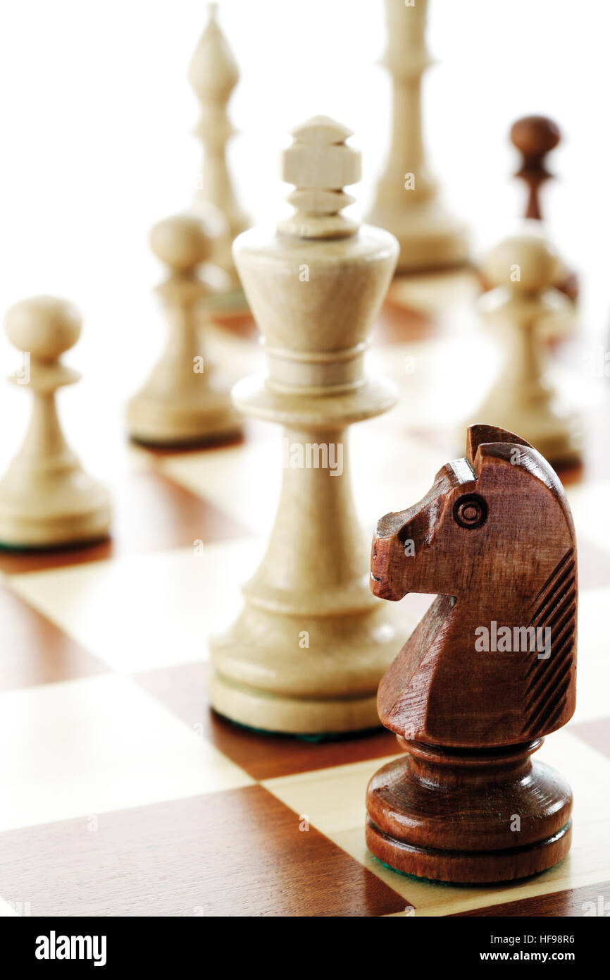 Chess pieces - knight, king, pawns and queen on chess board Stock Photo ...