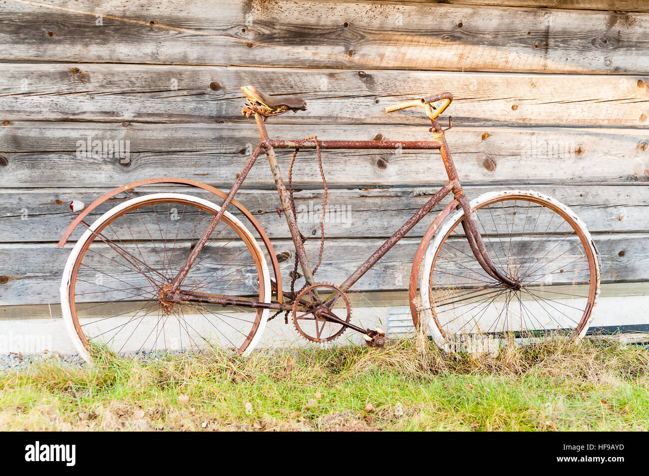 Old and rusty bike abandoned outside a wooden cabin a long time ago ...