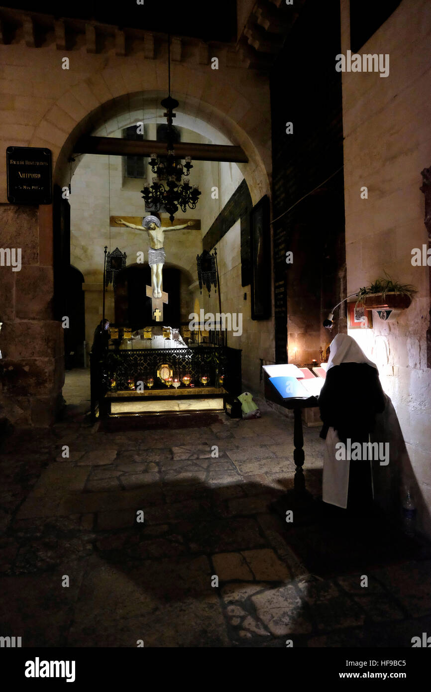 A Russian Orthodox nun reading the bible at the basement where remnants ...