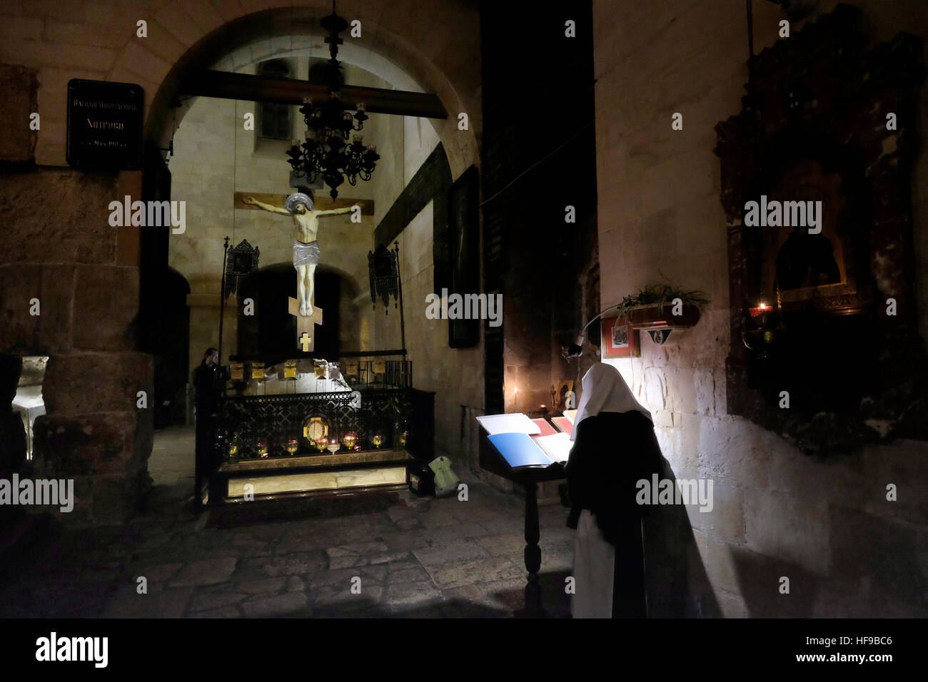 A Russian Orthodox nun reading the bible at the basement where remnants ...