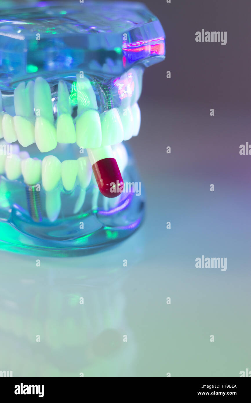 Plastic mouth taking a pill Stock Photo - Alamy