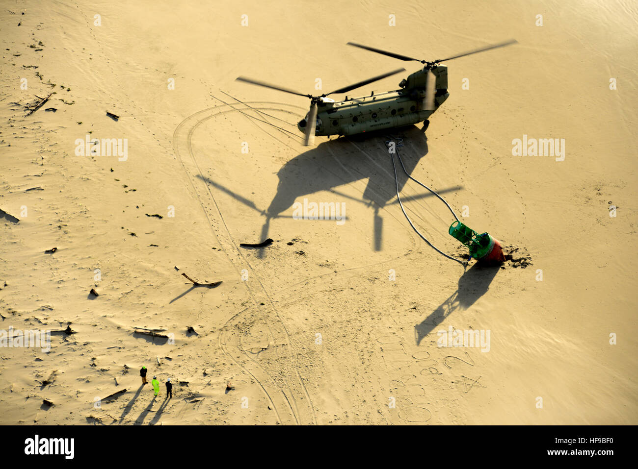 U.S. soldiers aboard a Boeing CH-47 Chinook helicopter rescue a beached ...