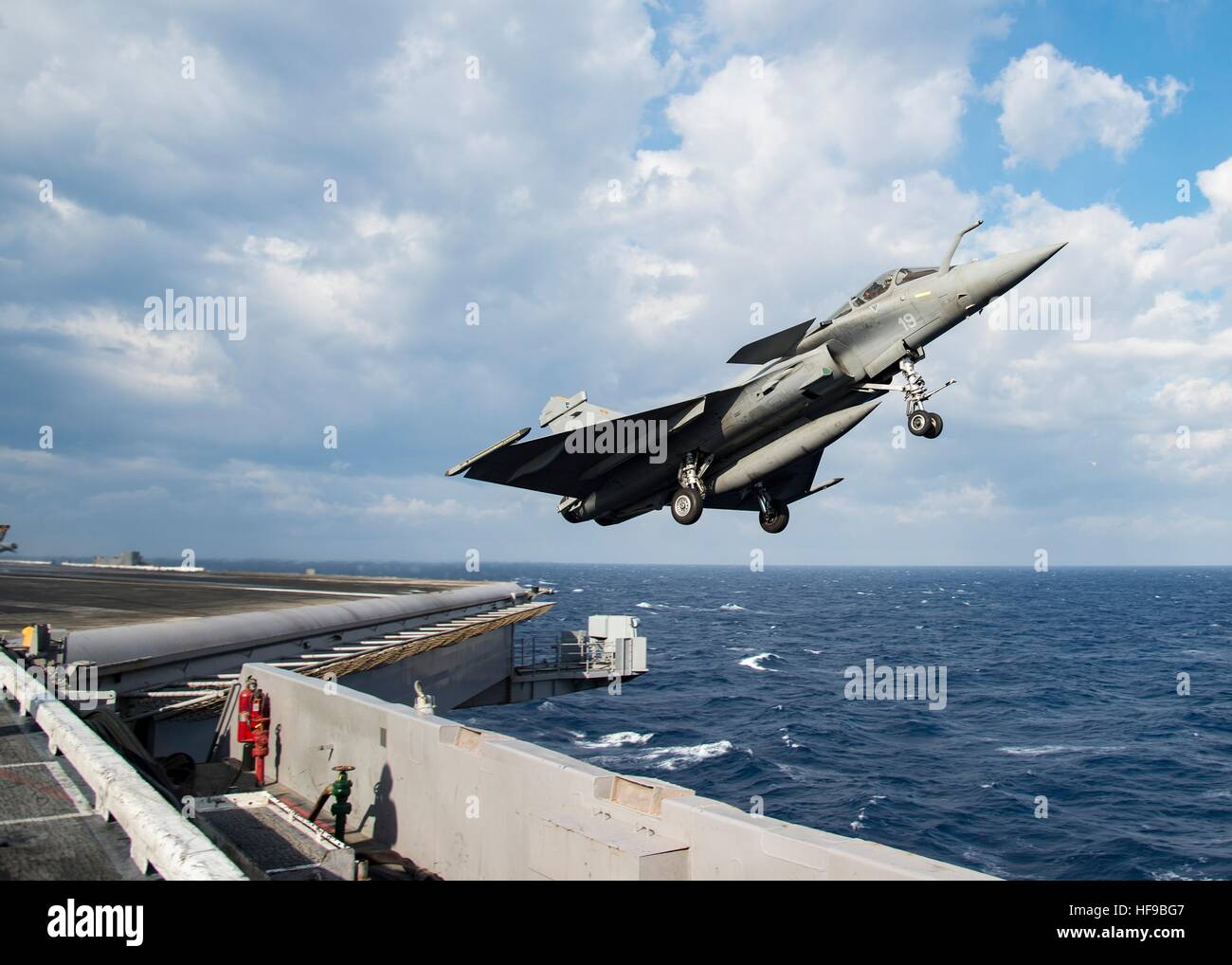 A French Navy Dassault Rafale aircraft performs a touch-and-go landing ...