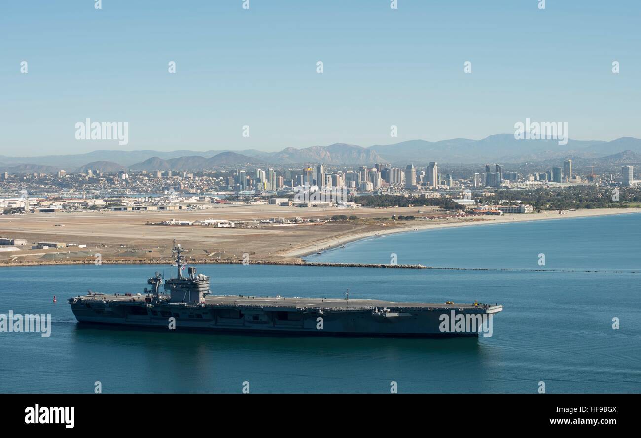 The USN Nimitz-class aircraft carrier USS Theodore Roosevelt departs the Air Station North ...