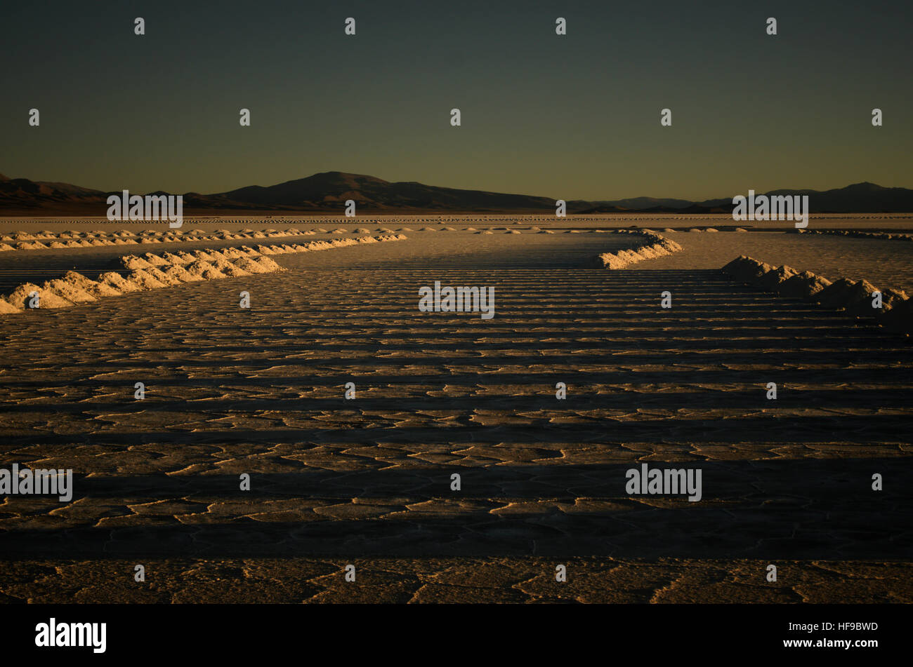 Salt mining with mountains and blue sky background Stock Photo - Alamy
