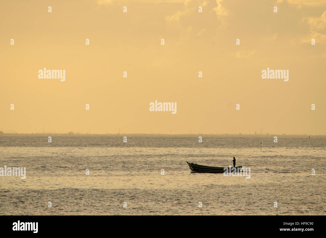 Man standing on a boat in a huge sea at sunset Stock Photo - Alamy