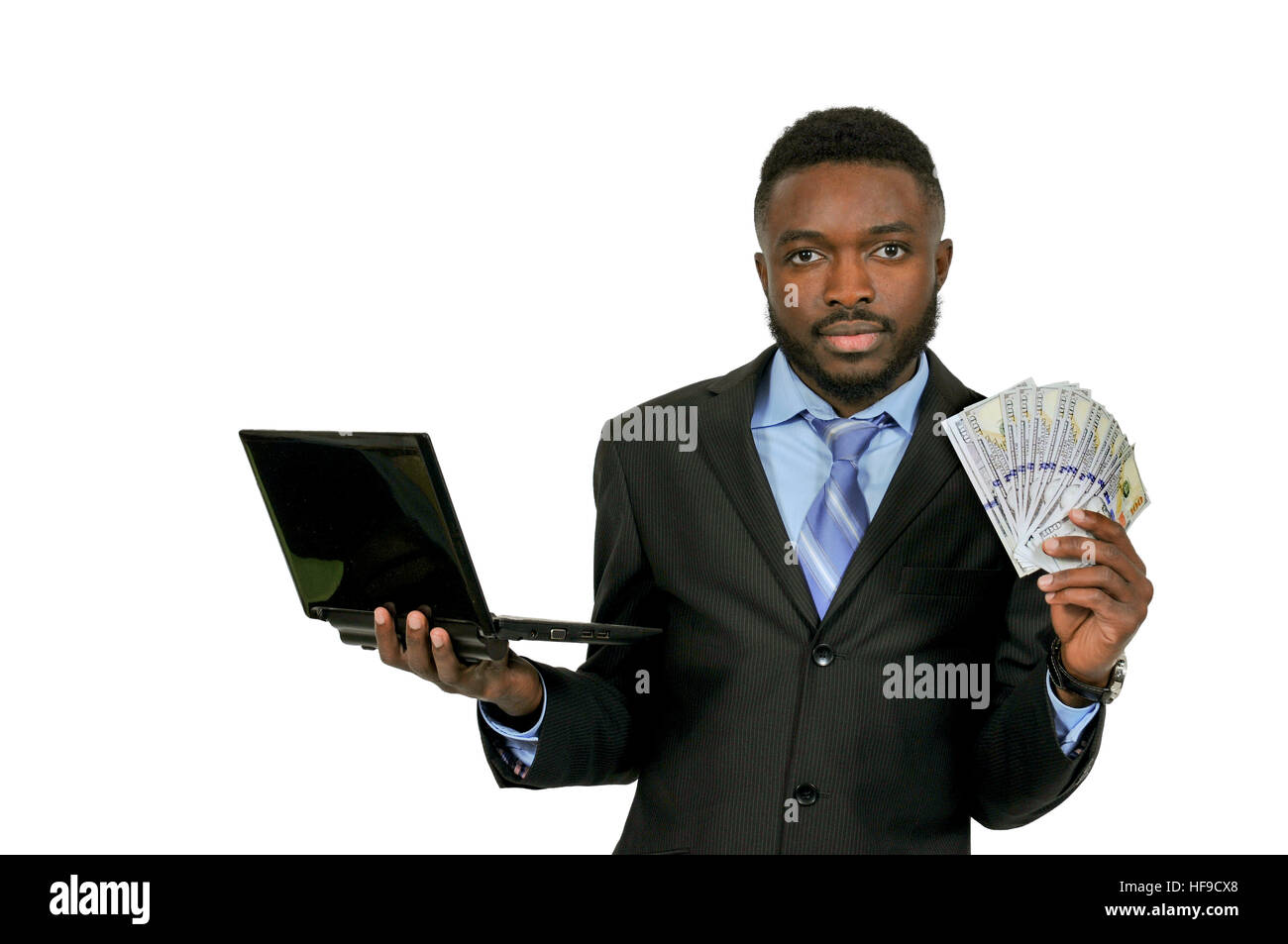 Handsome man with cash using a computer Stock Photo - Alamy