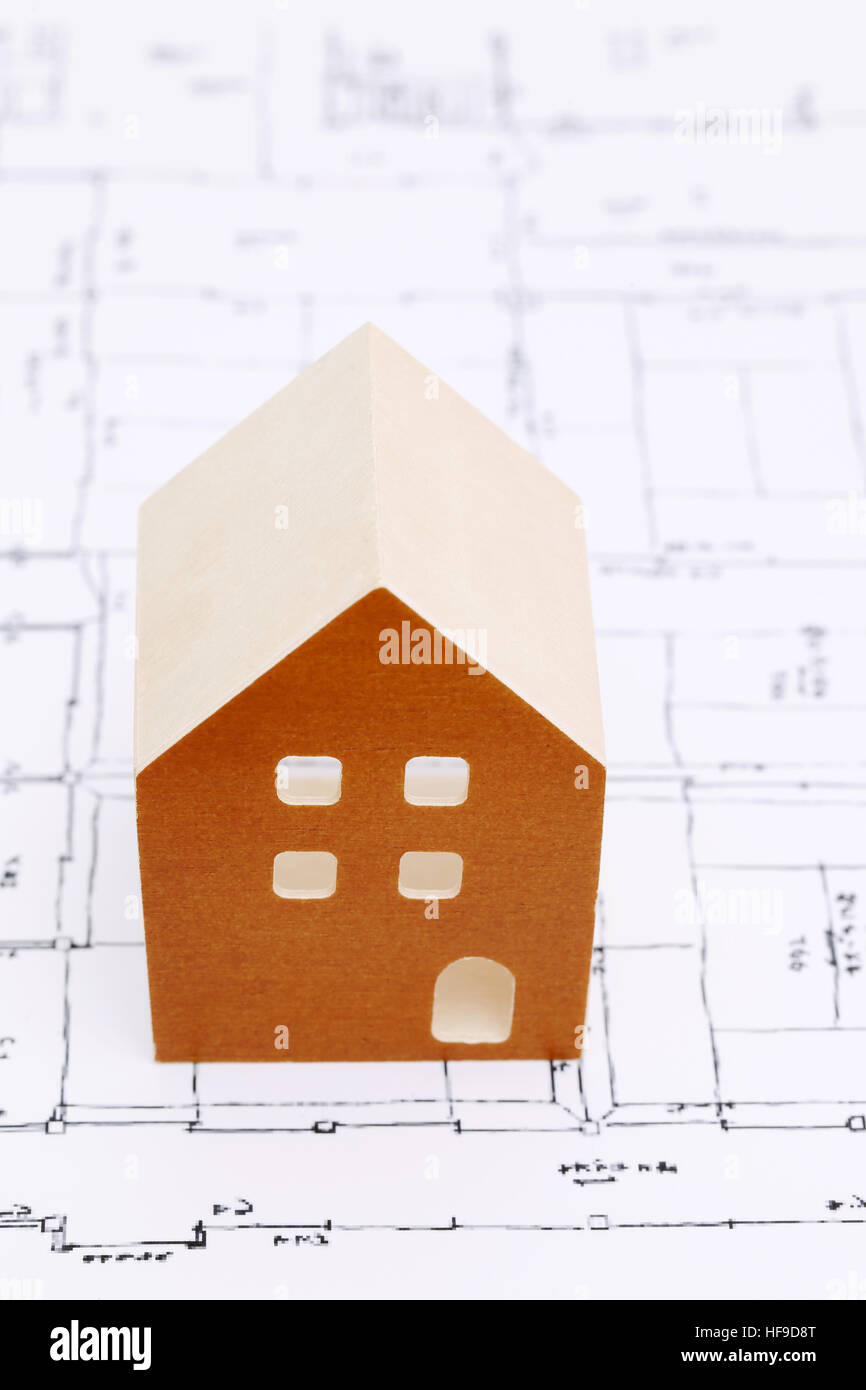 Wooden model of house on blueprints, construction plan Stock Photo - Alamy