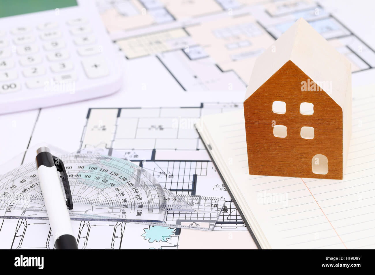 Miniature model of house and blueprints, construction plan Stock Photo ...