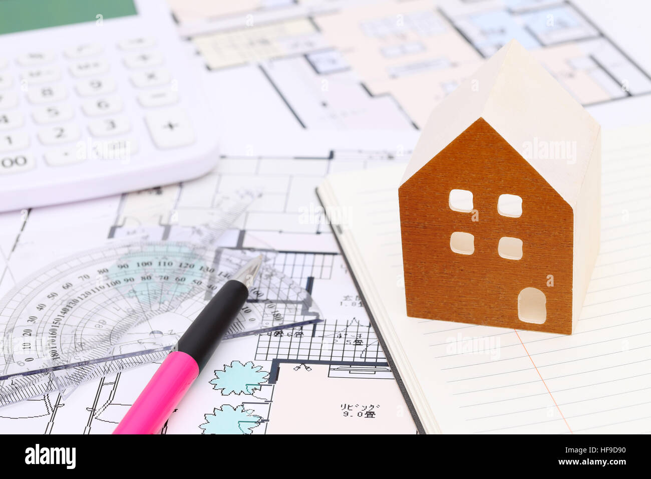 Miniature model of house and blueprints, construction plan Stock Photo ...