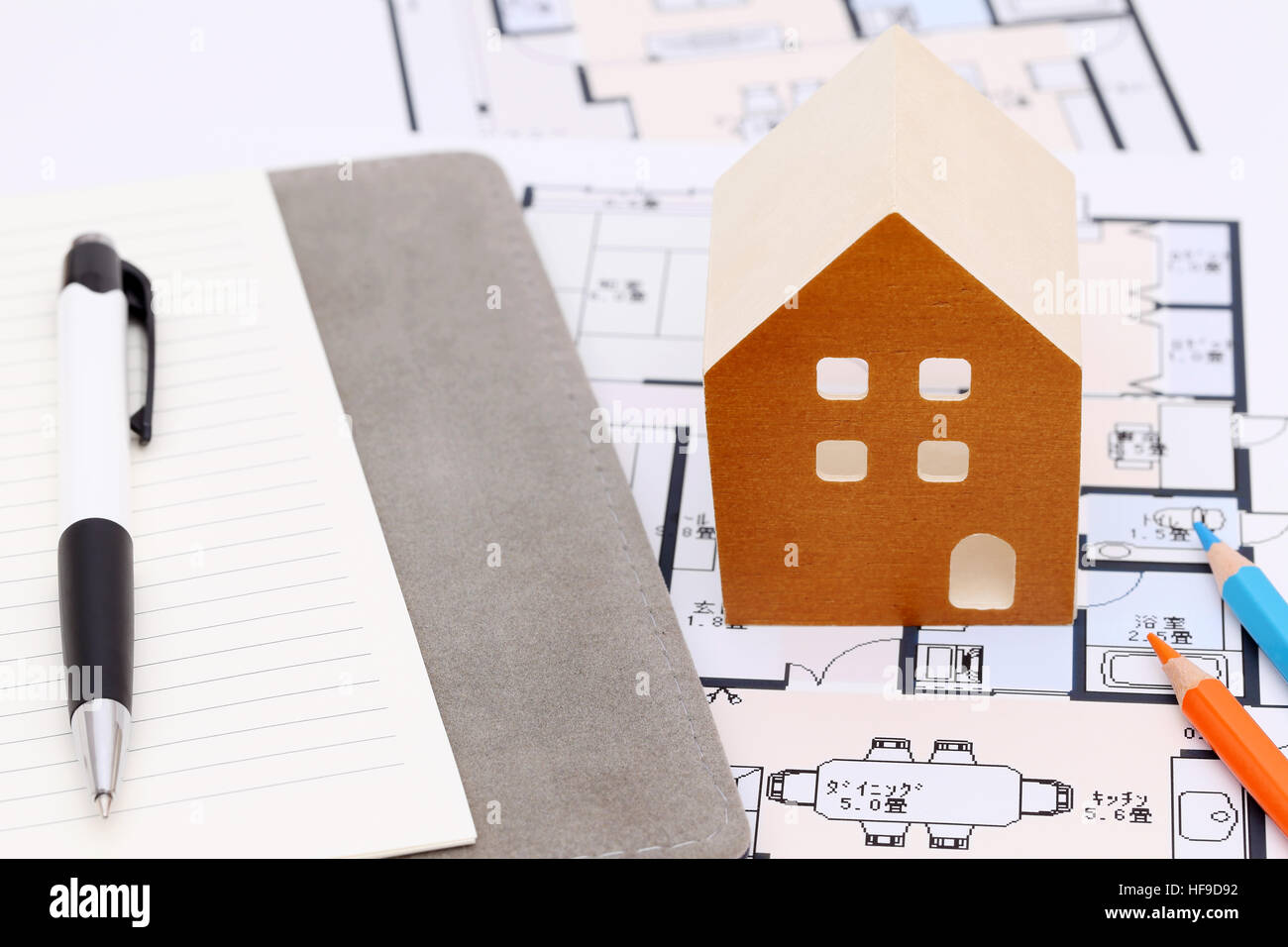 Miniature model of house on blueprints, construction plan Stock Photo ...