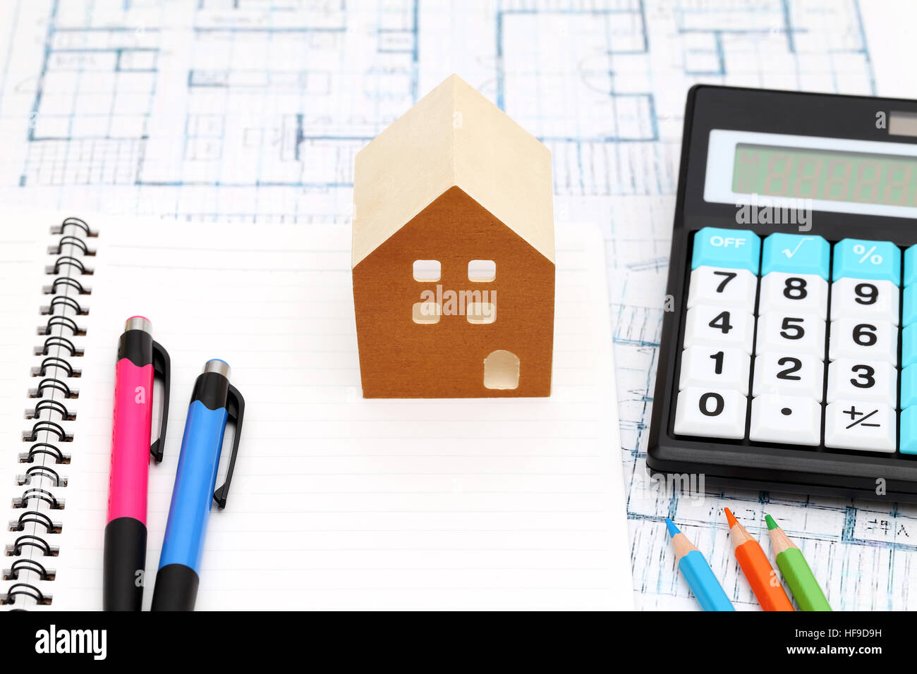 Miniature model of house and blueprints, construction plan Stock Photo ...