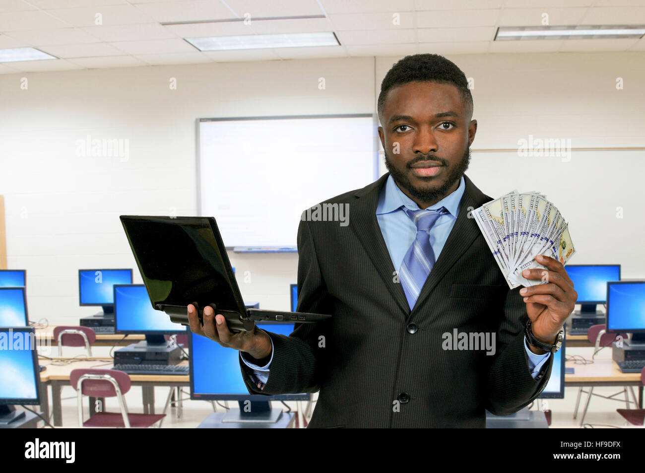 Handsome man with cash using a computer Stock Photo - Alamy