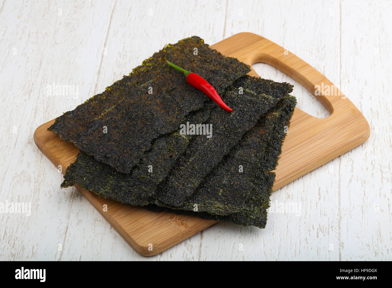 Spicy Nori seaweed sheets with pepper on wood Stock Photo - Alamy