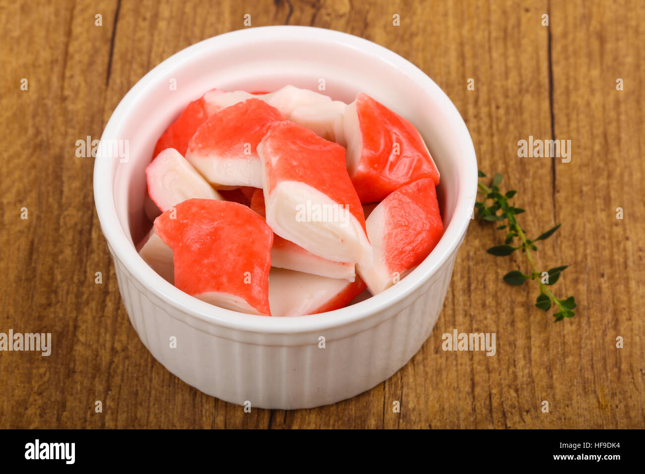 Crab stick - surimi in the plate - over wood background Stock Photo - Alamy