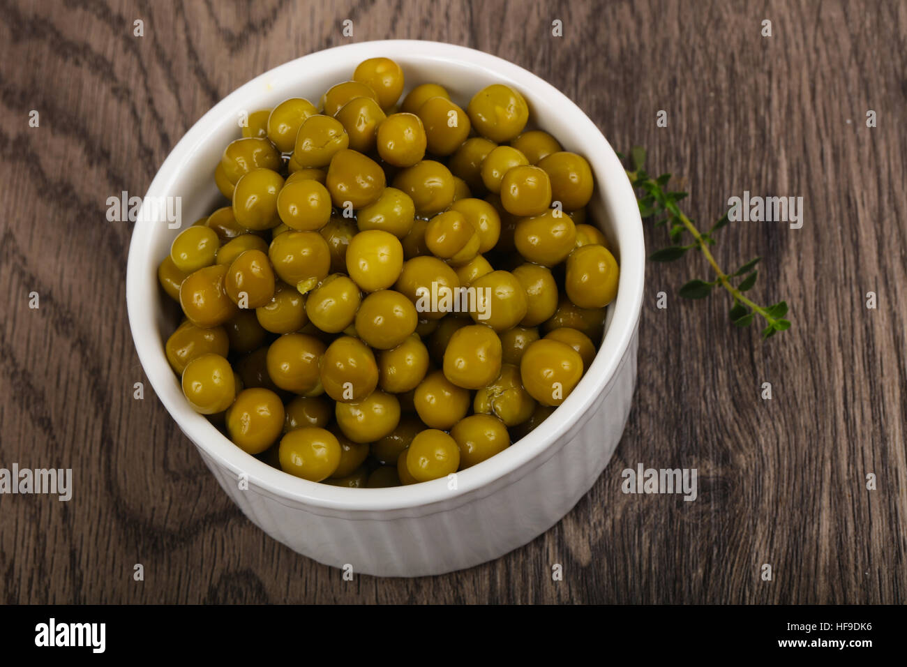 Pickled pea in the plate over wooden background Stock Photo - Alamy