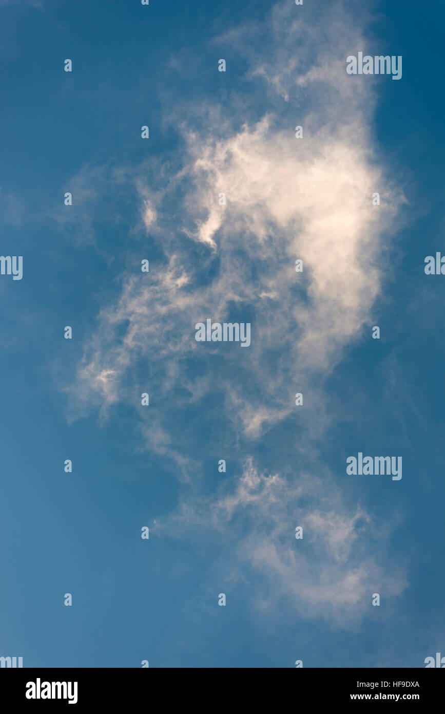 Elongated cloud in big blue sky Stock Photo - Alamy