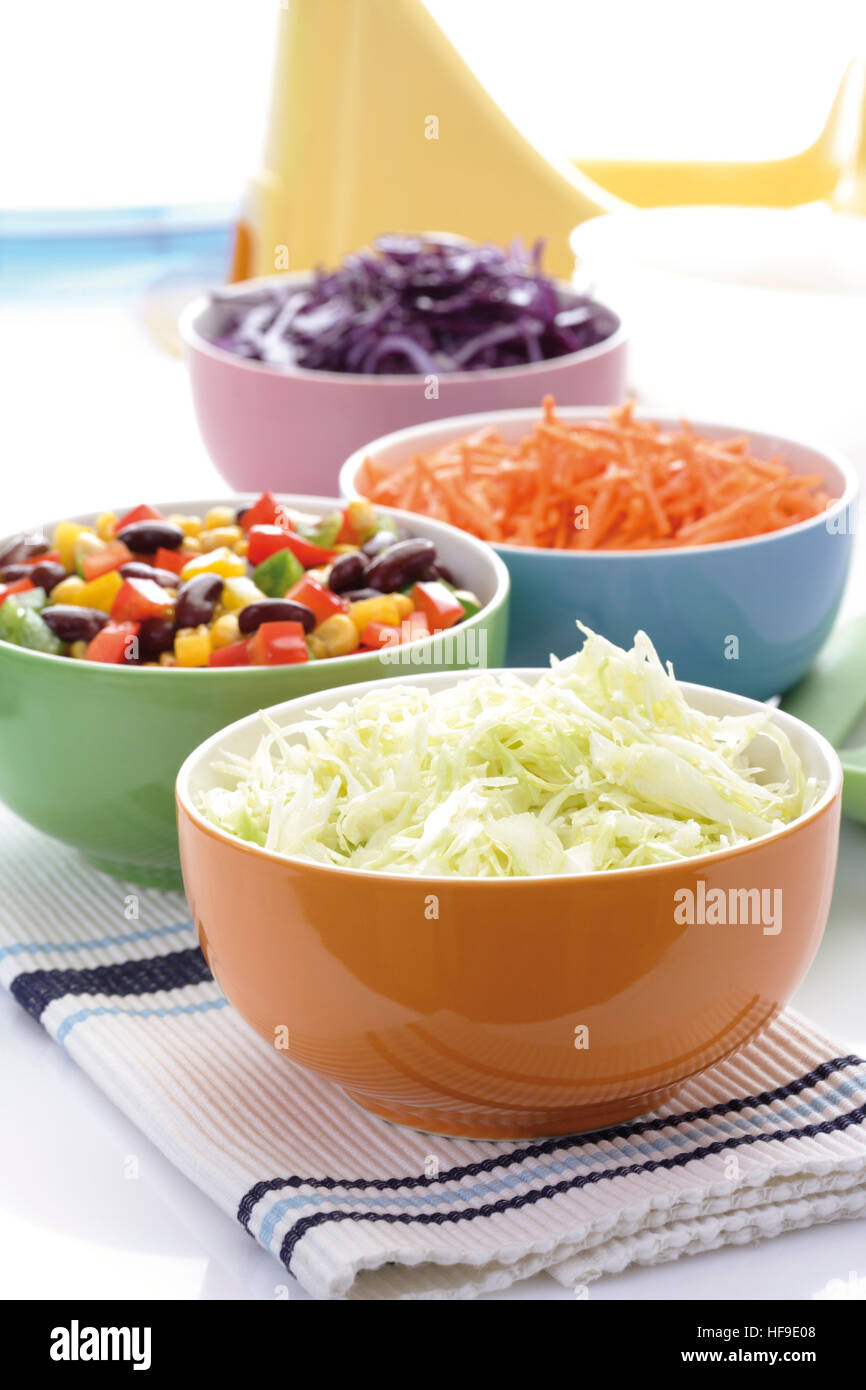 Various kinds of salad in bowls: white cabbage, Mexican salad ...