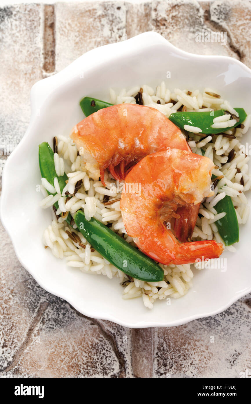 Rice dish with shrimp, pea pods, long-grain rice and wild rice, closeup ...