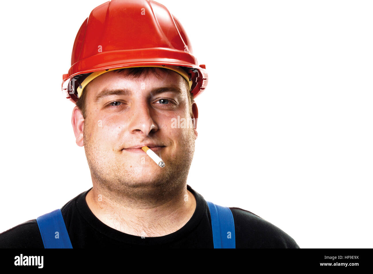 Construction worker wearing red hardhat smoking a cigarette Stock Photo ...