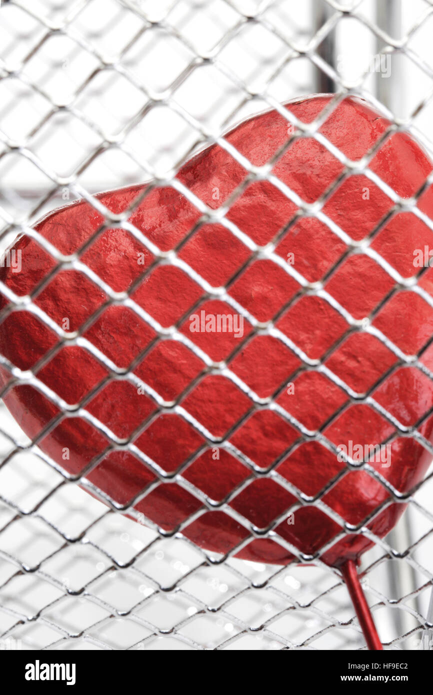 Heart behind fence, locked away Stock Photo - Alamy