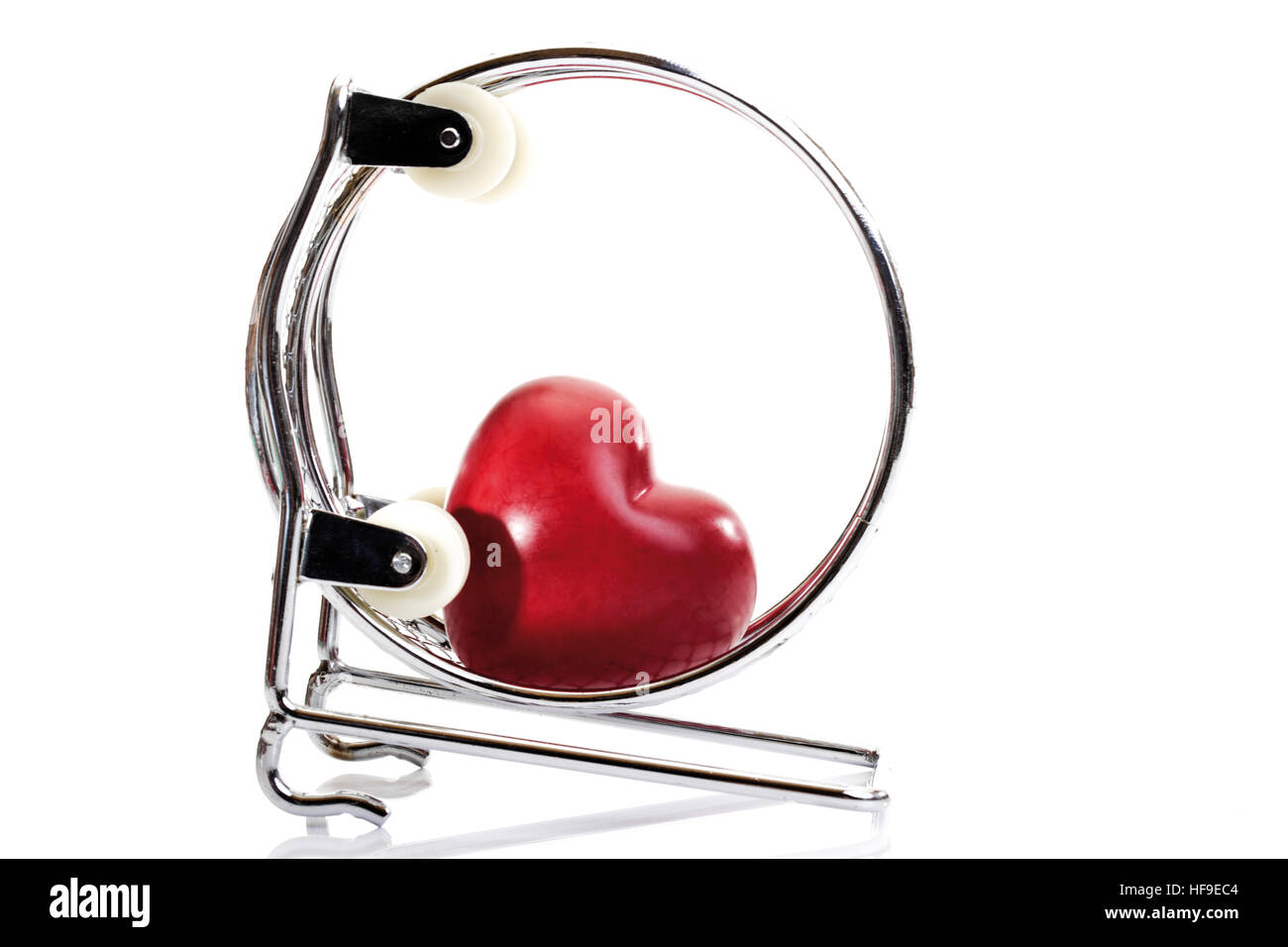 Red heart in a hamster wheel: athlete's heart syndrome Stock Photo - Alamy